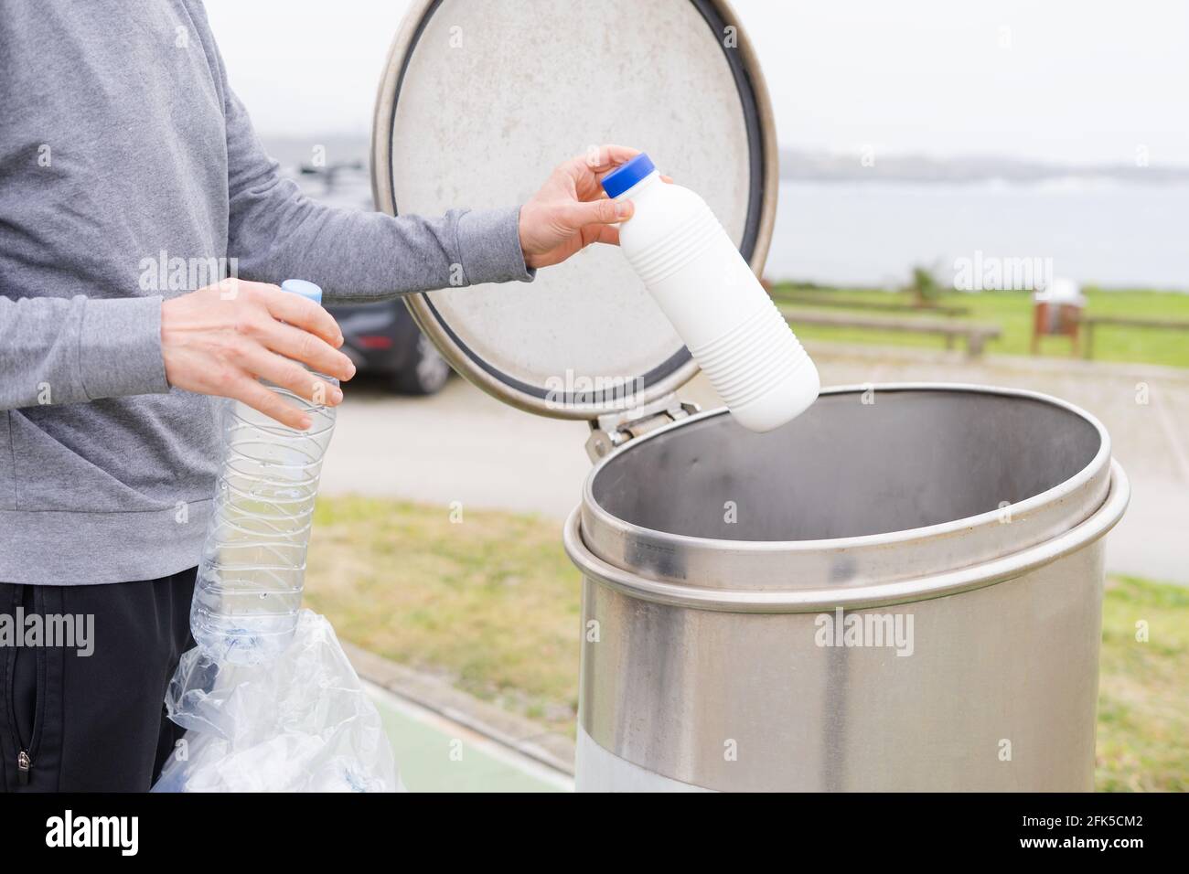 Man throwing plastic containers at recycling point. Social ...