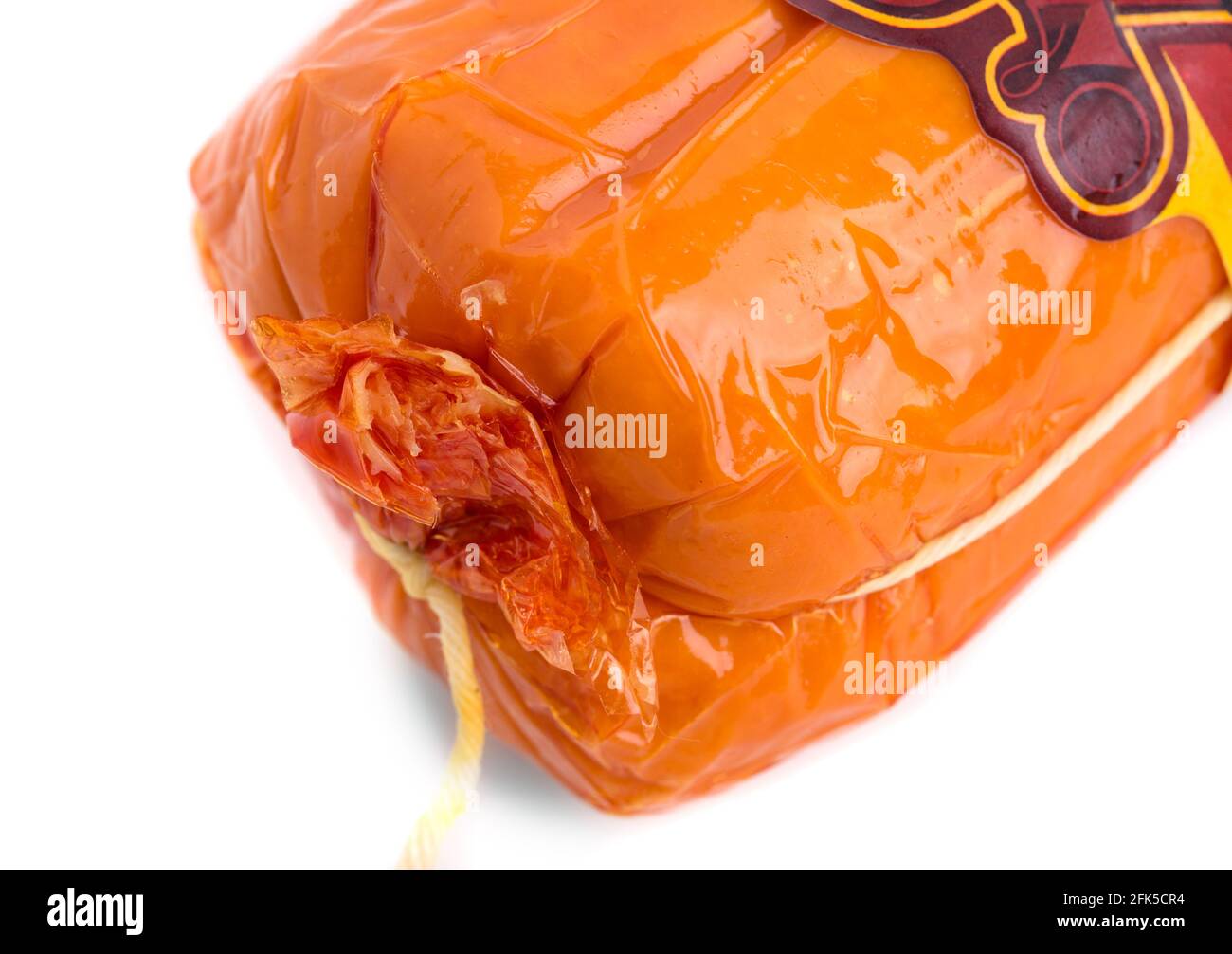 Closeup of chicken ham stick with rope in artificial casing. Macro ...