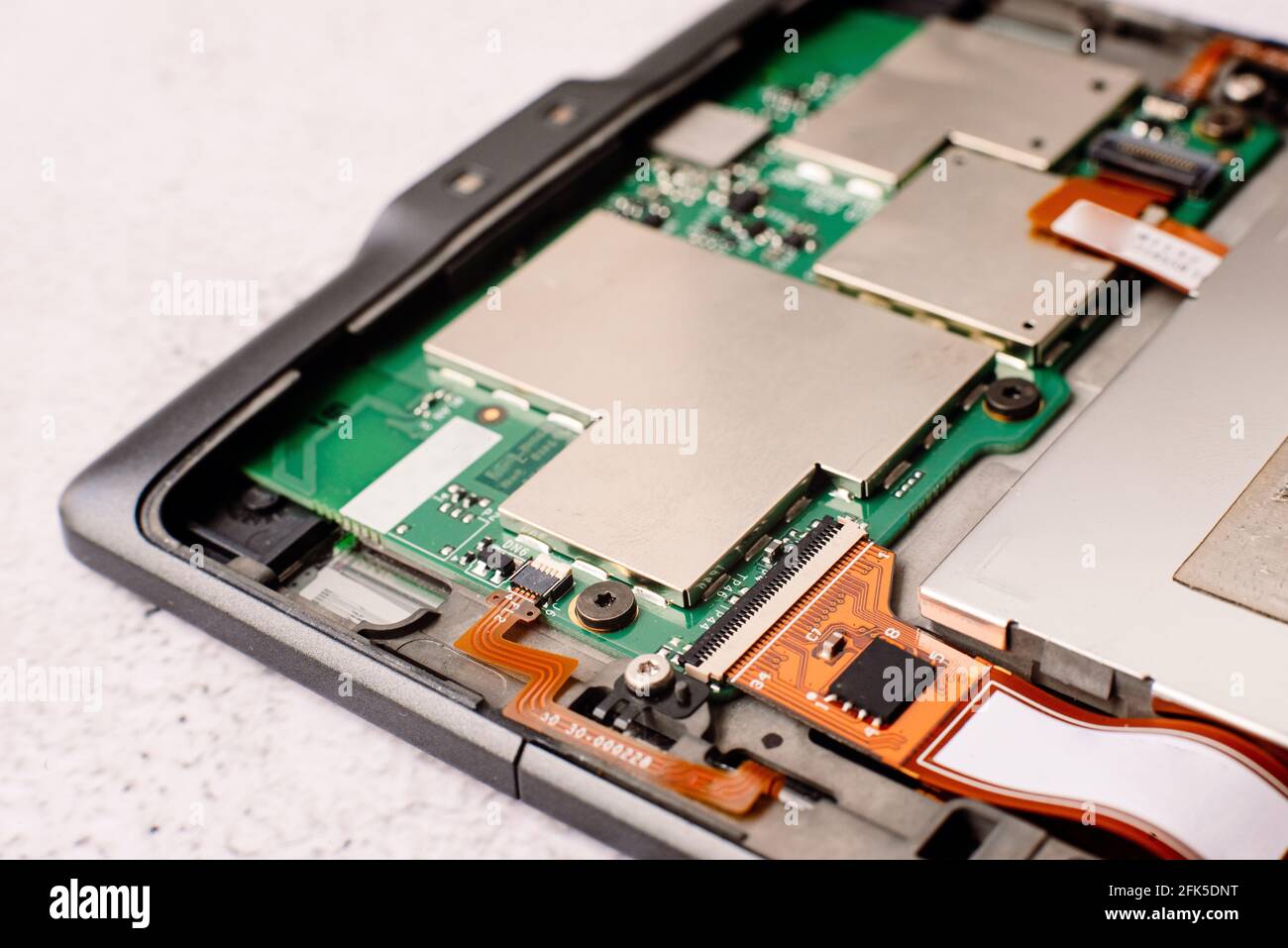 Interior of a small electronic device, with motherboard and transistors ...