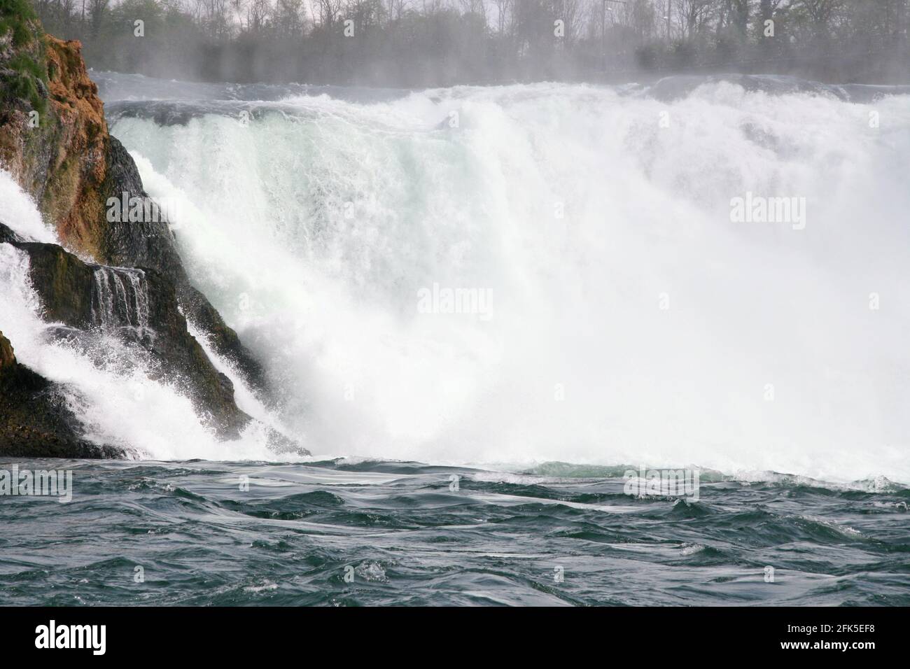 a waterfall with white, foaming in spray Stock Photo - Alamy