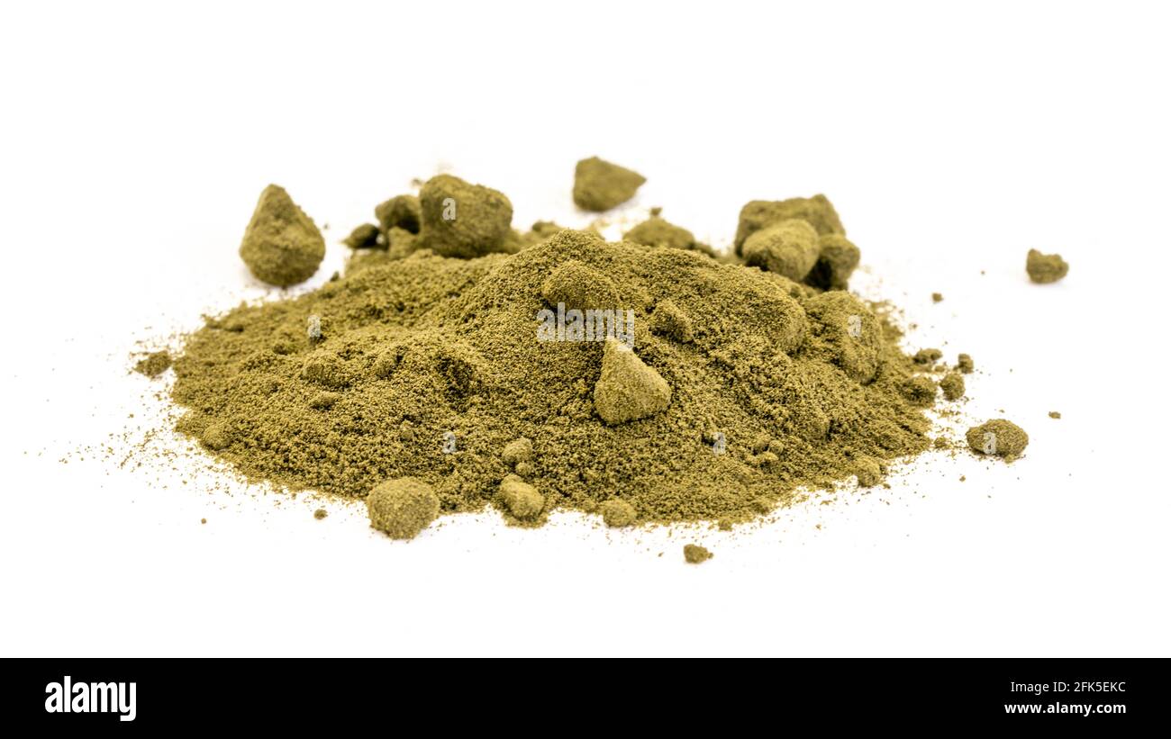 wheatgrass powder heap on a white plate, alkalizing green superfood ...