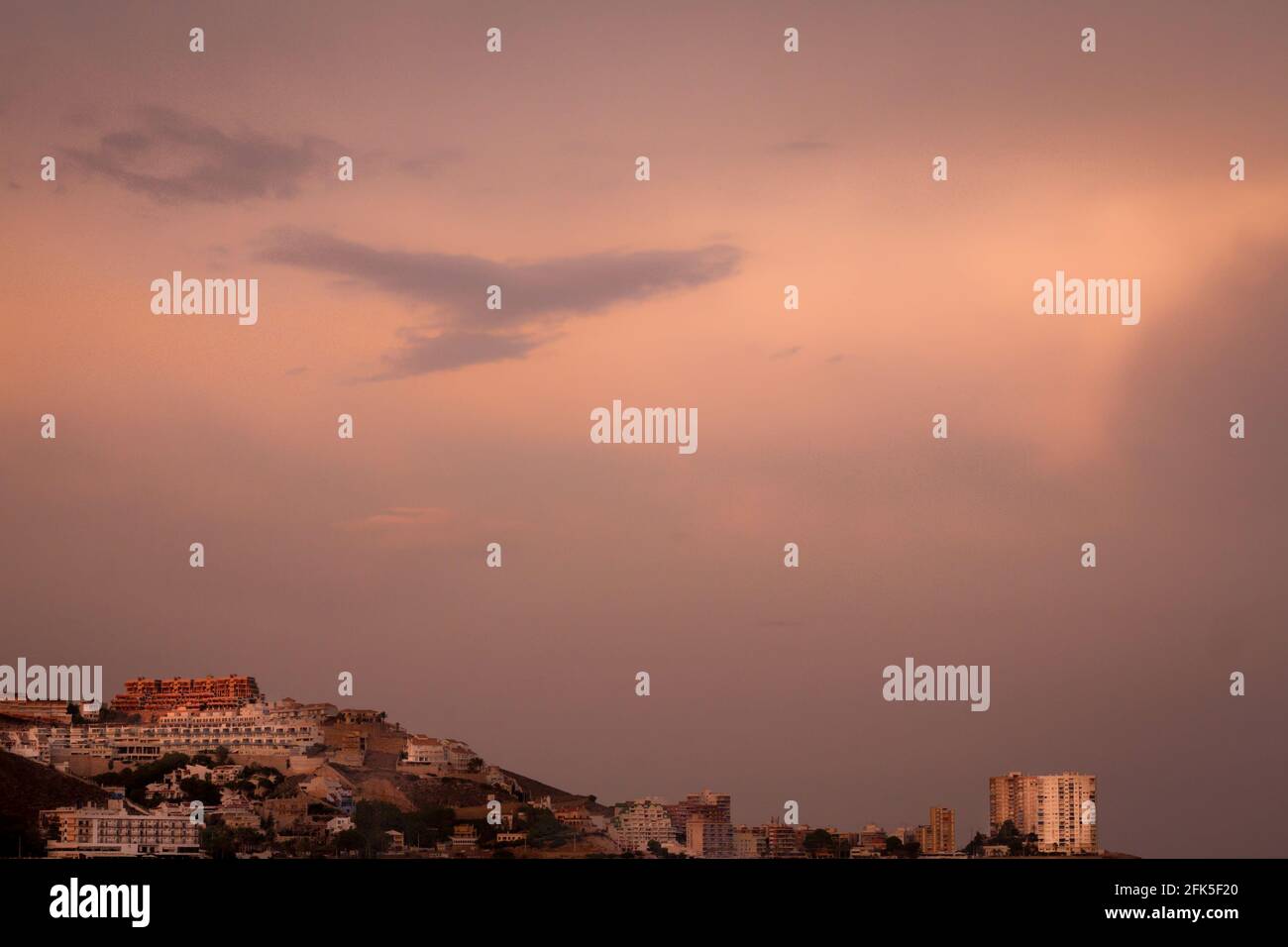 Beautiful shot of fiery red sunset seen through buildings located on ...