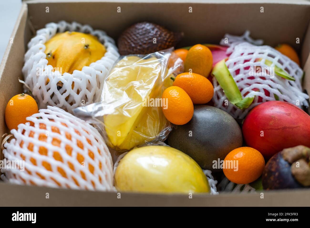 Still life of fruit in a box isolated on white Stock Photo - Alamy