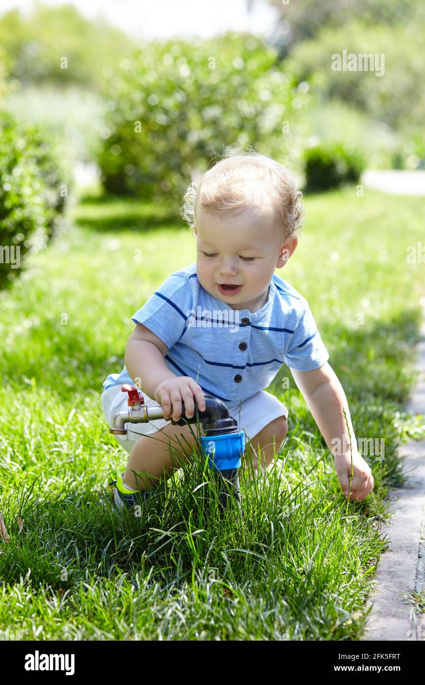 Little boy play in the city park. The concept of a happy childhood ...
