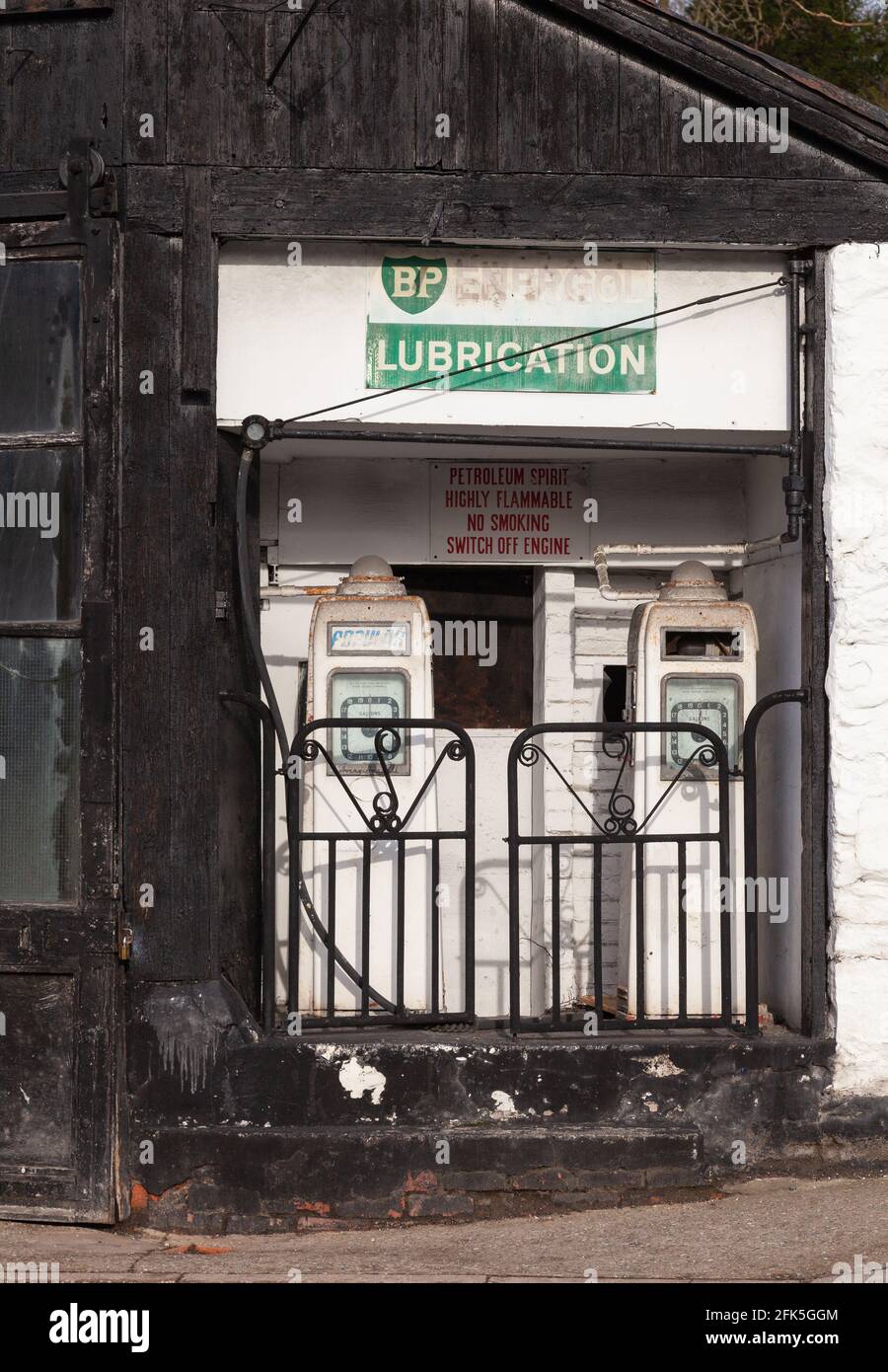 Derelict garage front with old broken petrol pumps Stock Photo - Alamy