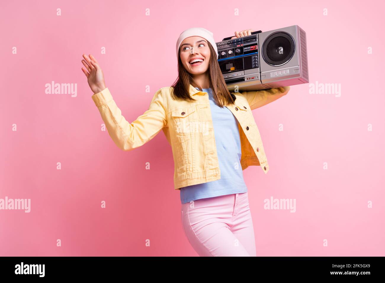 Photo of young happy smiling girl woman female raise hand hold boombox ...