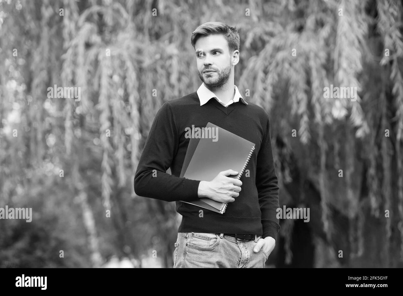 Smart handsome man reading book Black and White Stock Photos & Images ...