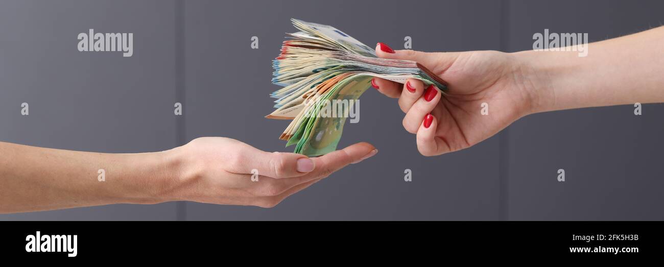 Woman handing cash money hi-res stock photography and images - Alamy