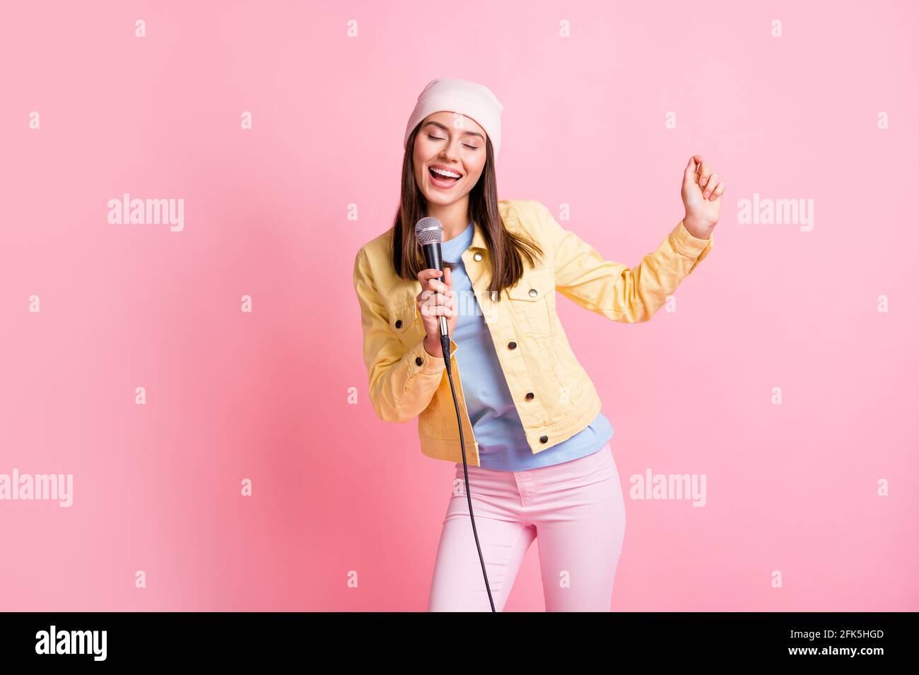 Photo of funky cute girl sing in karaoke dance wear cap jacket shirt ...