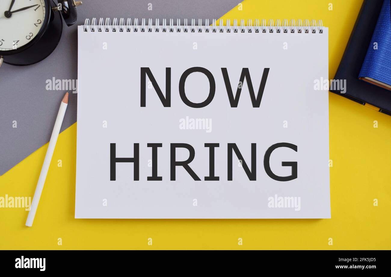 Concept NOW HIRING message written in Notebook Stock Photo - Alamy