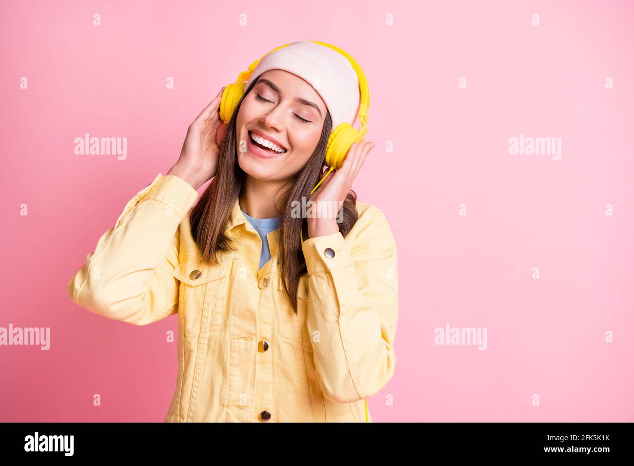 Portrait of charming young person listen to nice music touch headphones ...