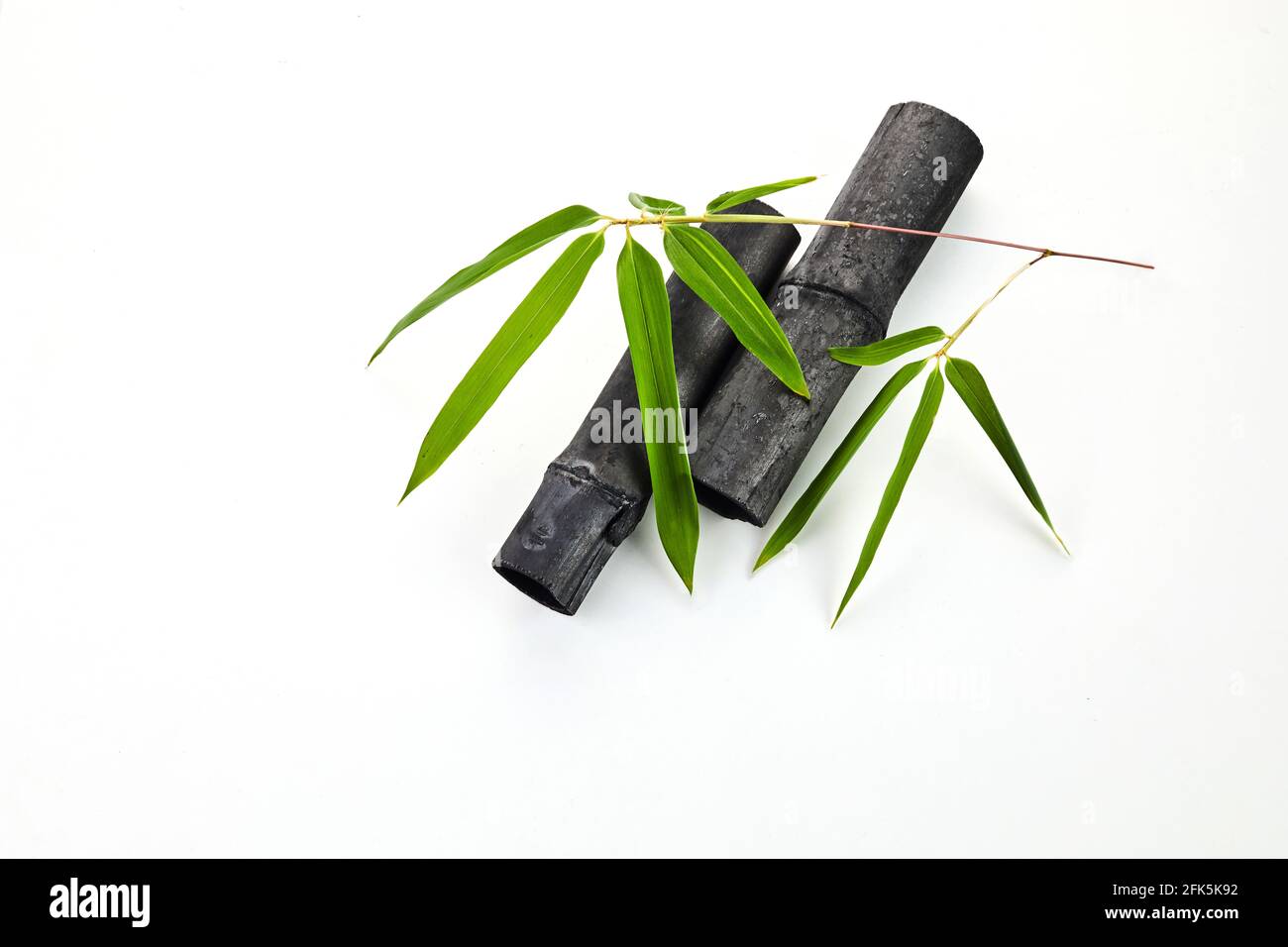Natural bamboo charcoal stocks with leaves isolated on white background ...