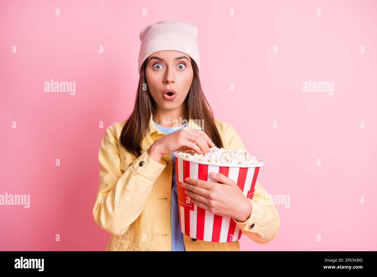 Photo of pretty lady arms holding popcorn staring confused open mouth ...