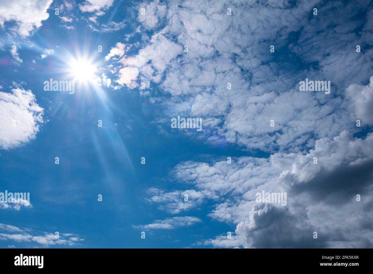 beautiful white sun and clouds on blue sky Stock Photo - Alamy