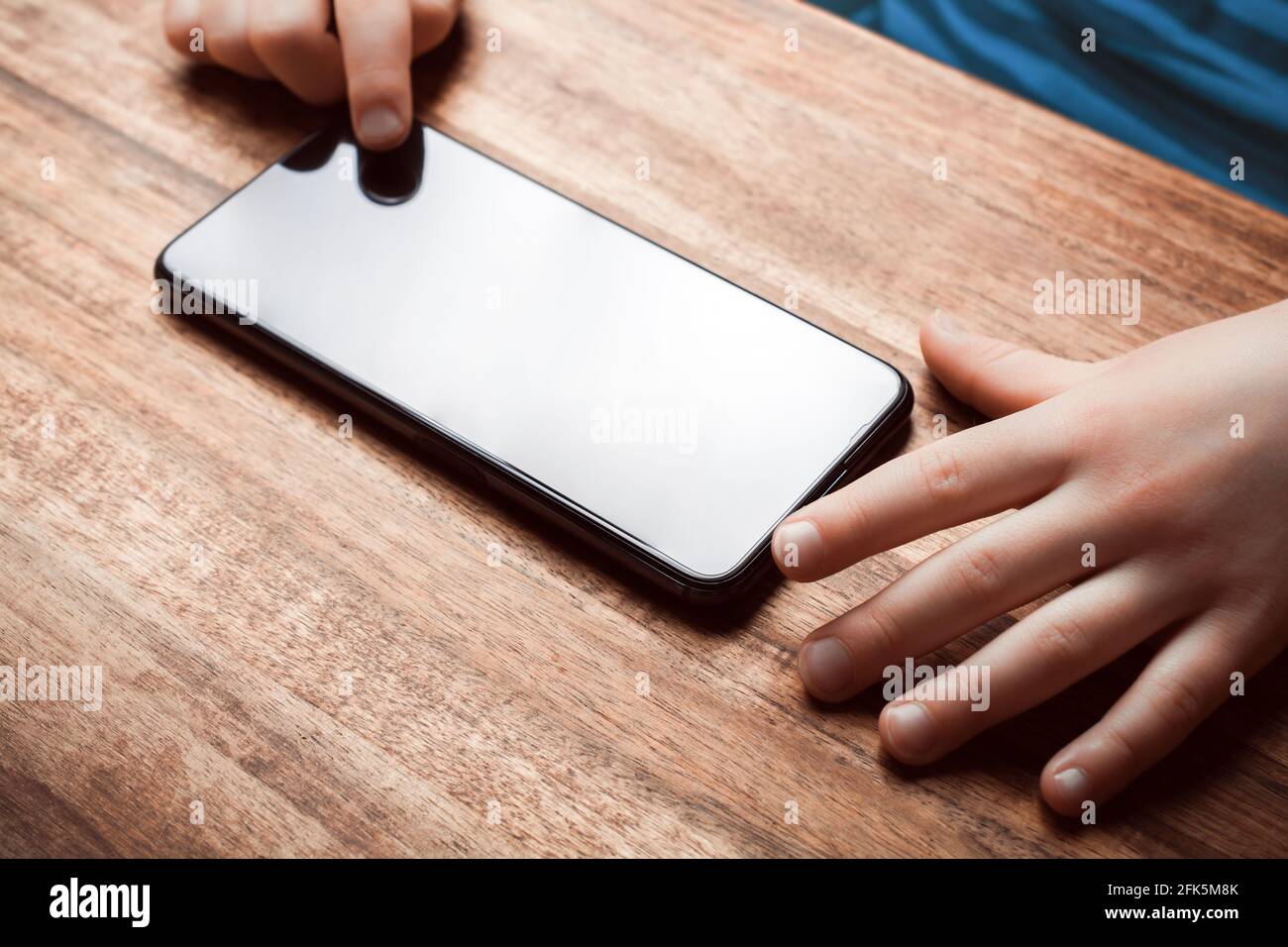Child Playing With Smartphone On A Table - Prevent Child Smartphone ...