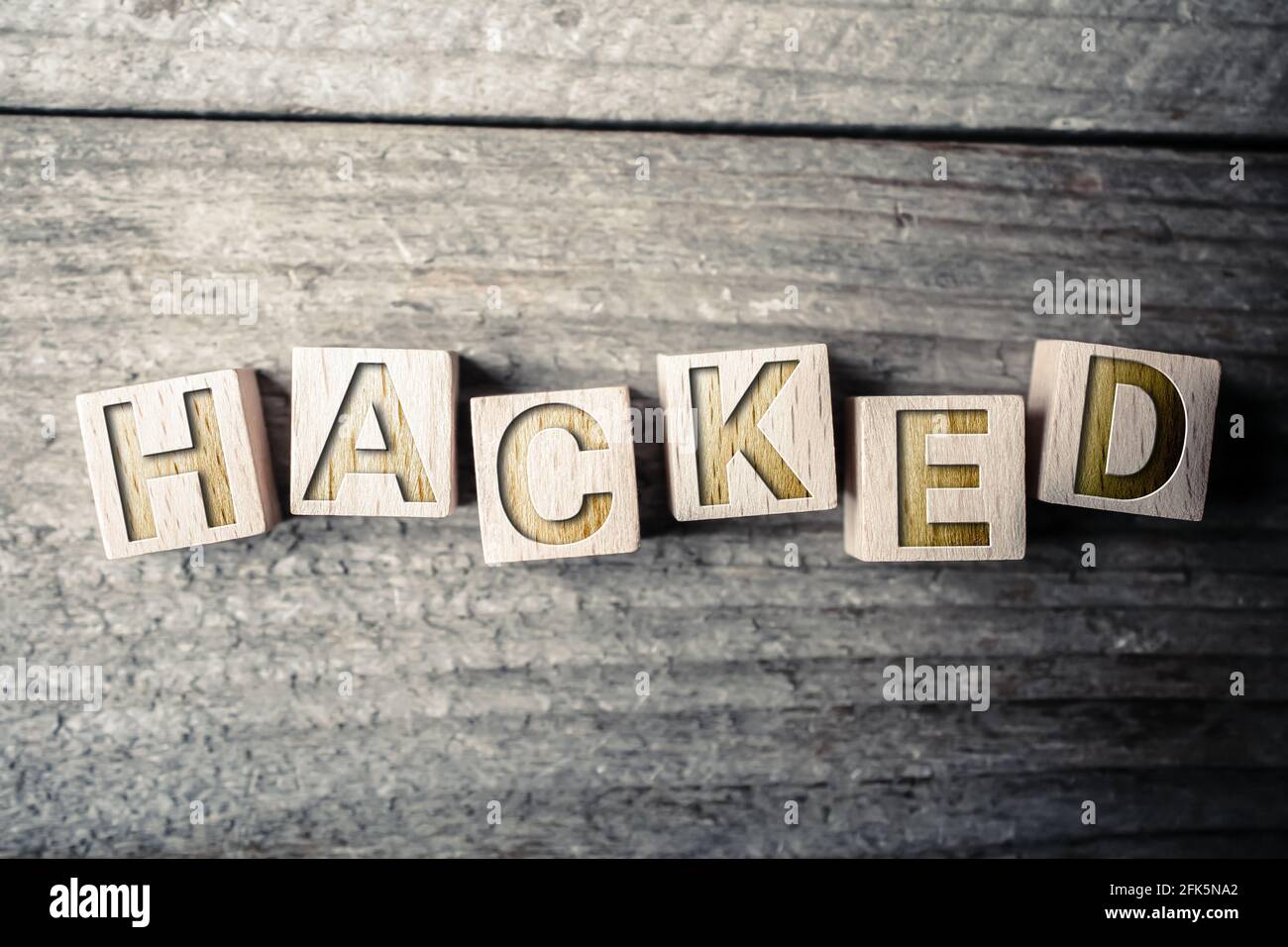 Hacked Written On Wooden Blocks On A Board Stock Photo - Alamy