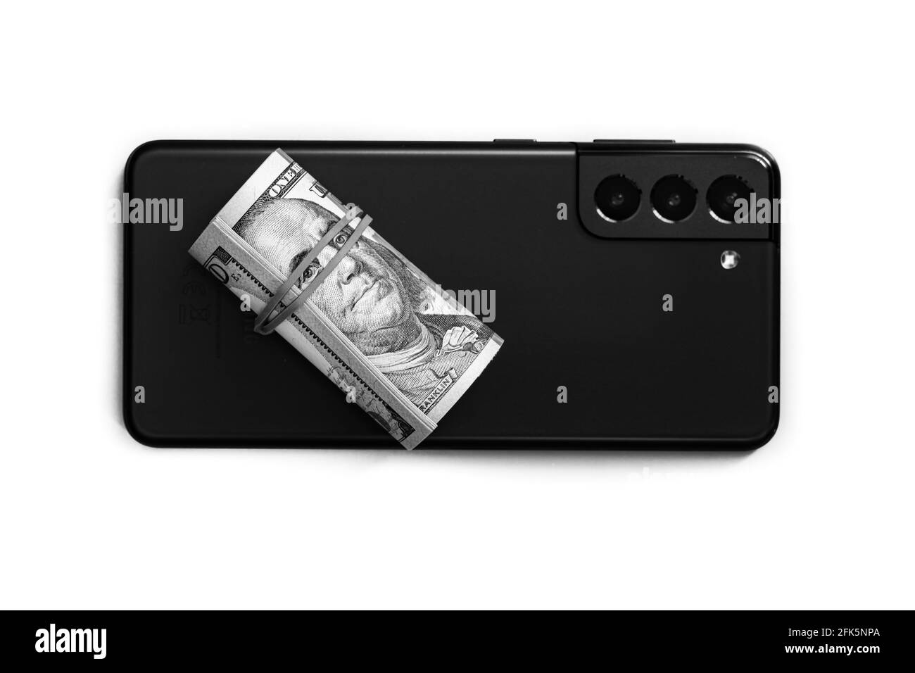 Phantom Grey smart phone and roll of 100 dollar banknotes Stock Photo ...