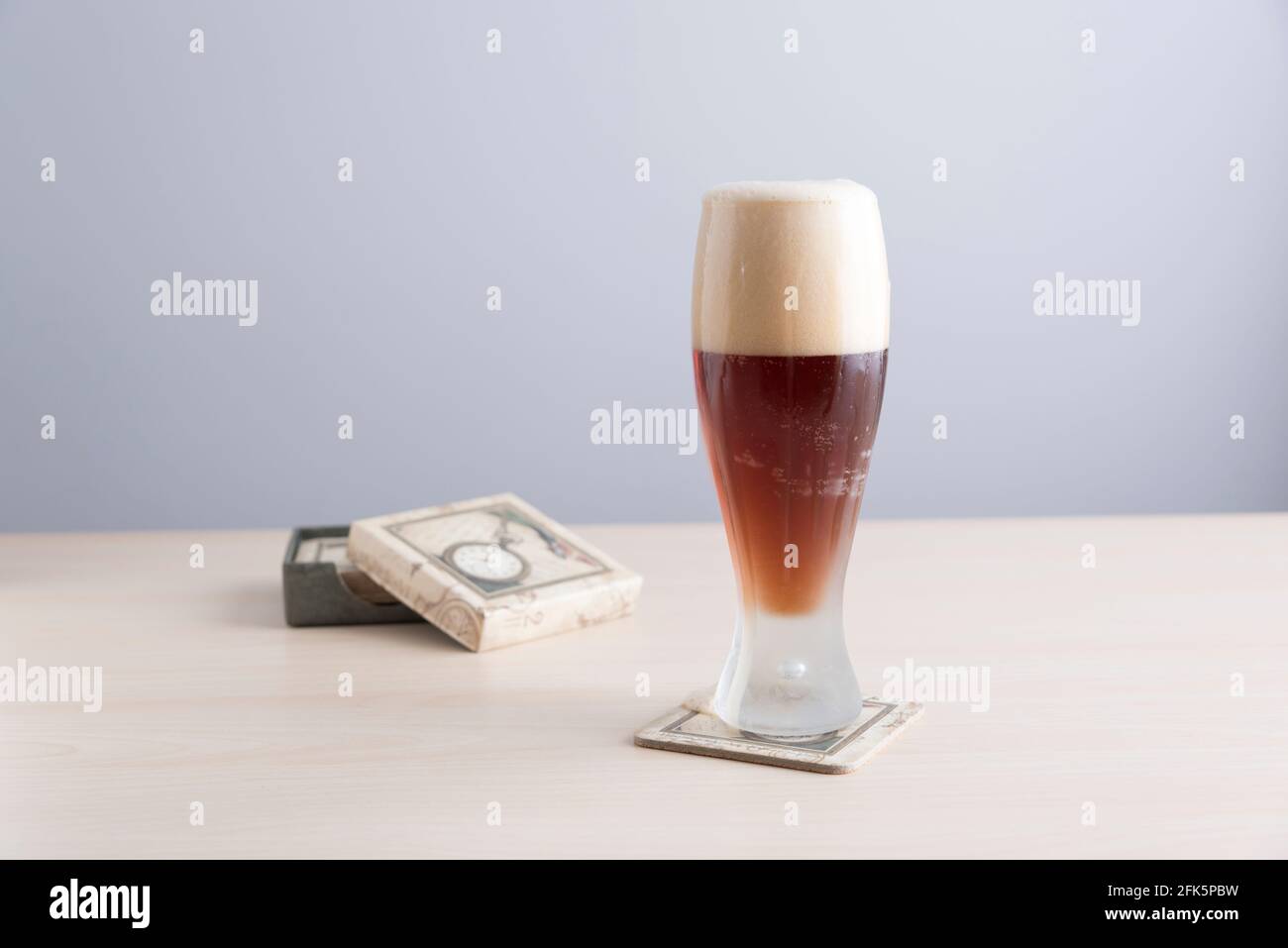 Tall glass filled ice cold amber ale Stock Photo - Alamy