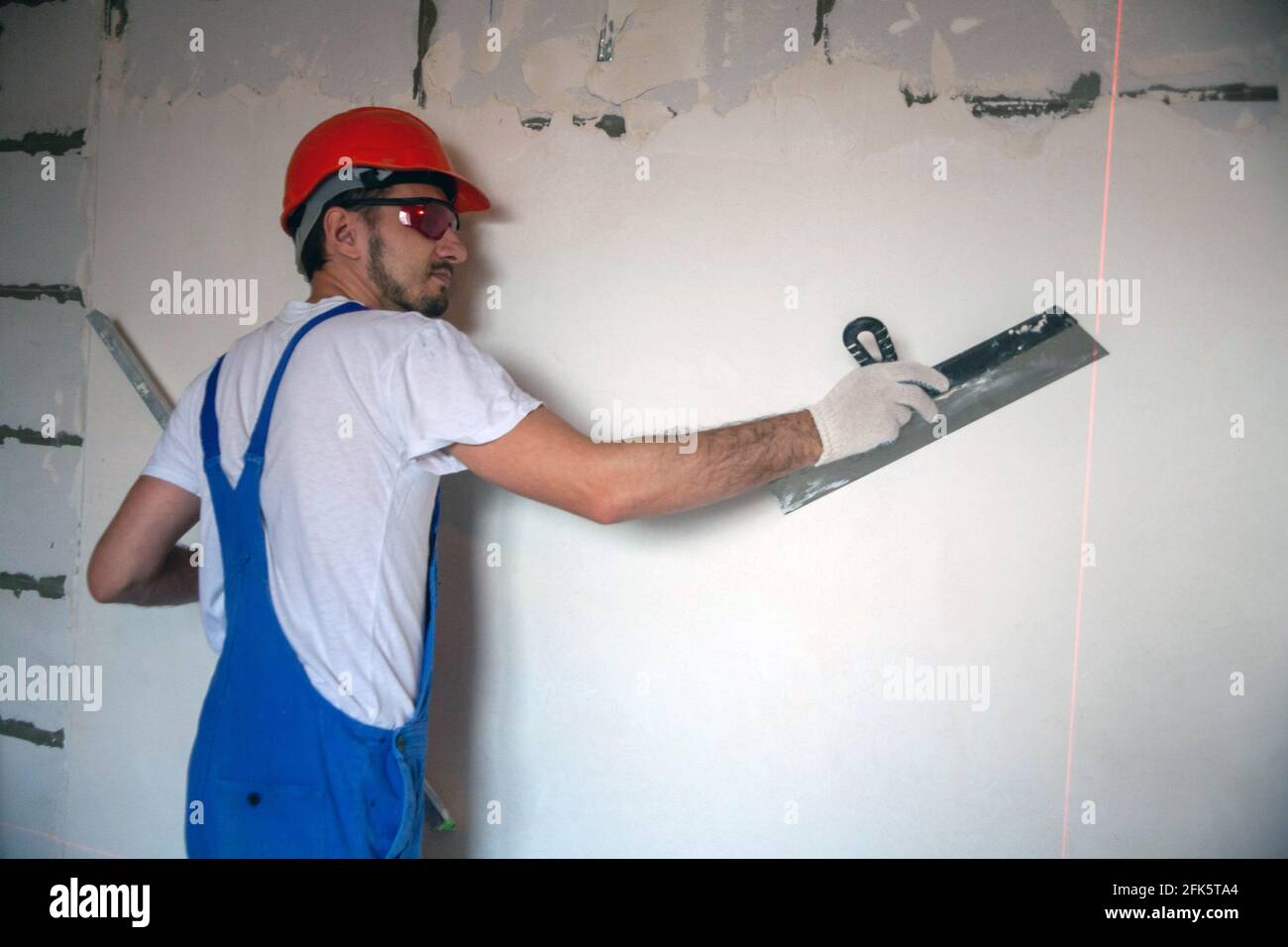 work on finishing the walls with mixtures of plaster and putty when ...