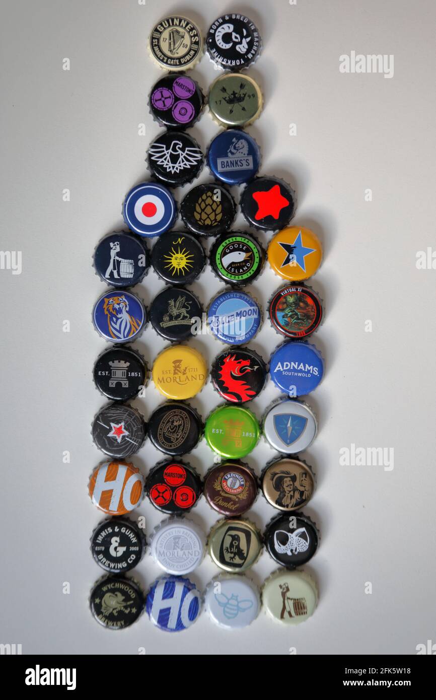 A number of beer bottle tops laid out in the shape of a bottle Stock ...