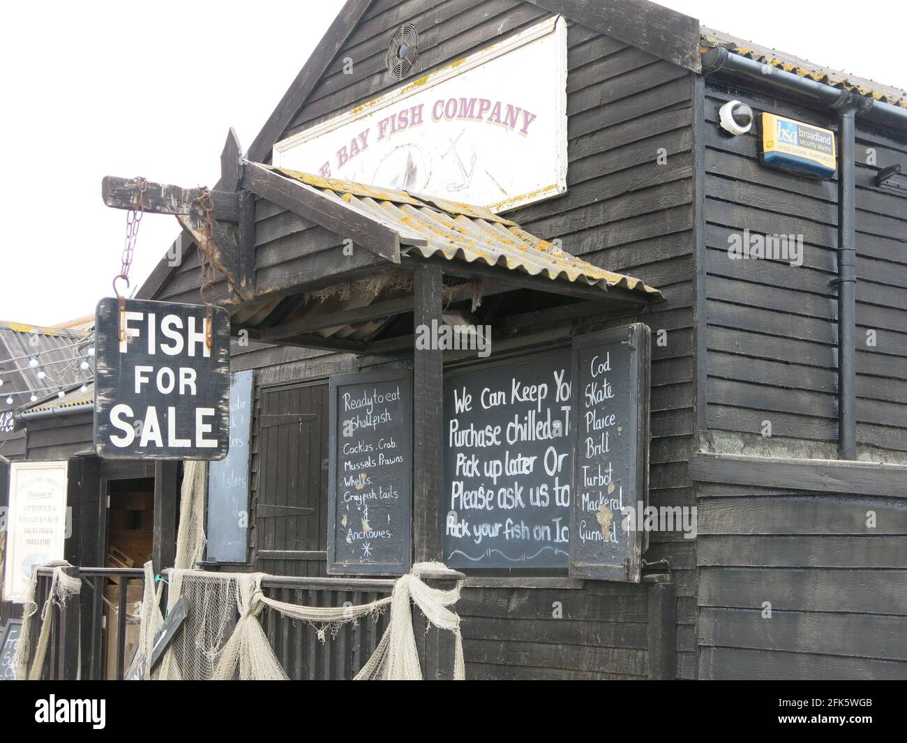 "Fish for Sale" sign hanging outside the black weatherboard hut of the ...