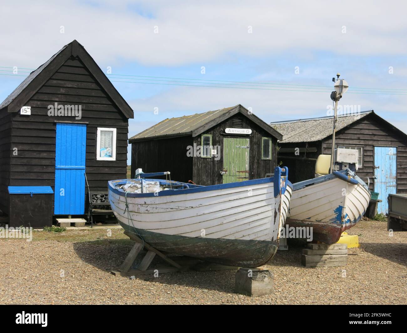 Traditional wooden black fishermen's huts along Southwold Harbour with ...