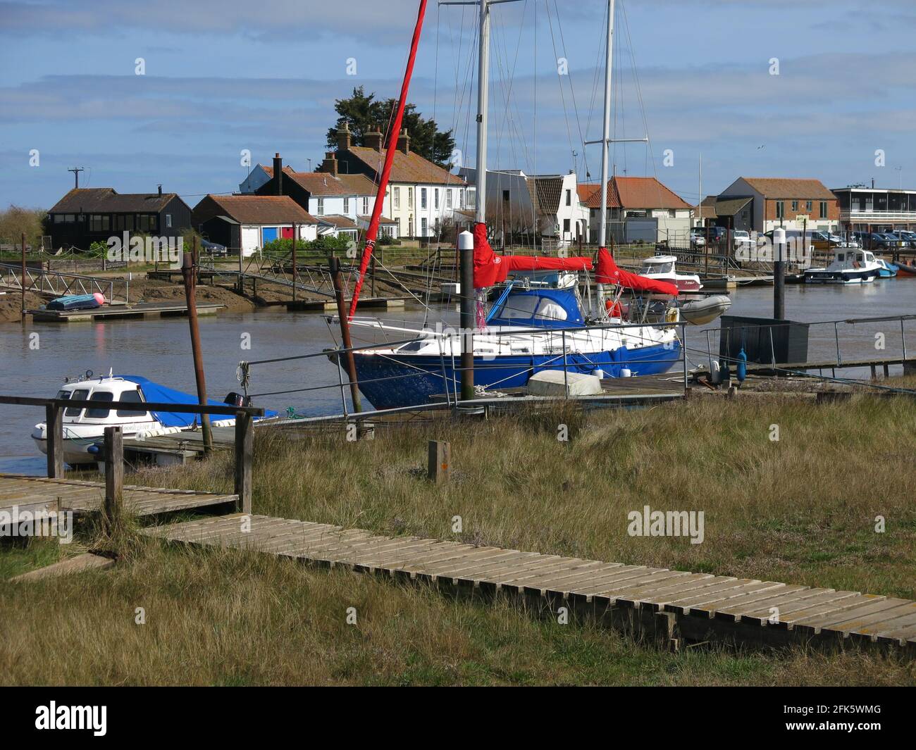 View of jetty and boats from the Walberswick side of the River Blyth ...
