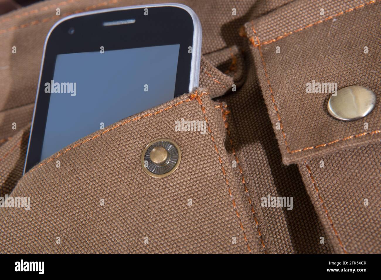 smartphone in open pocket of fabric bag Stock Photo - Alamy