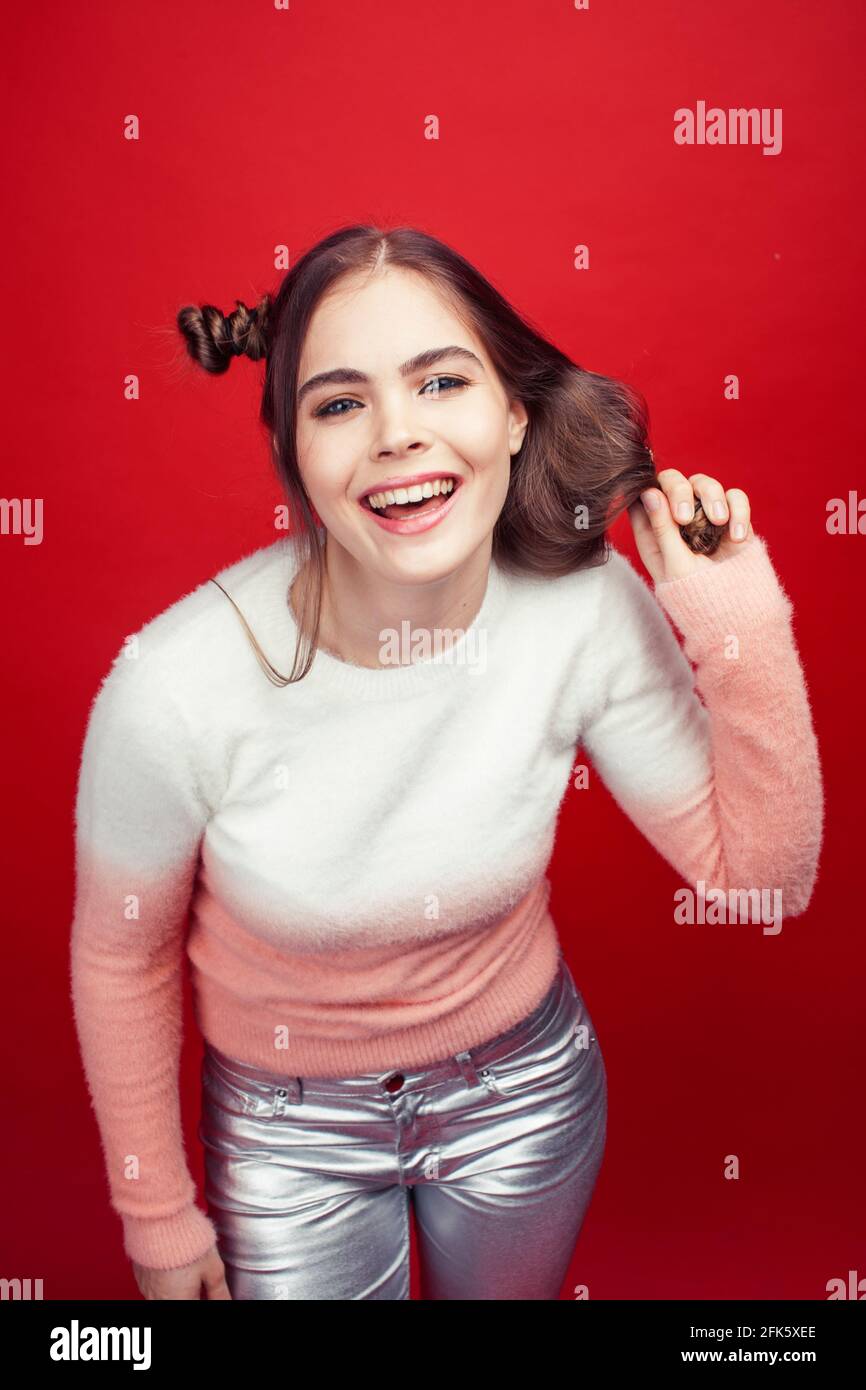 young pretty emitonal posing teenage girl on bright red background ...