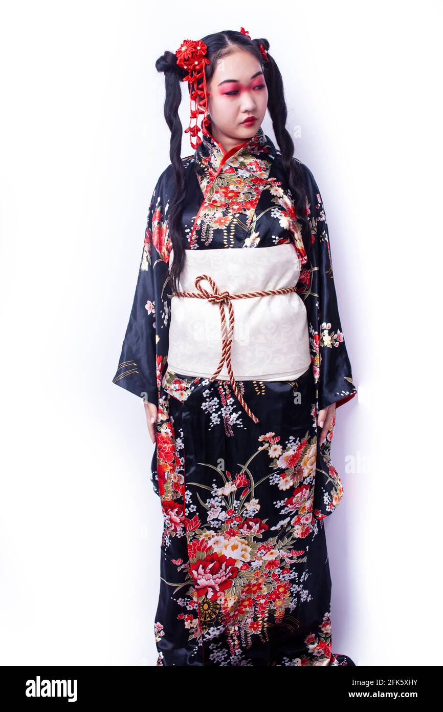 young pretty geisha in black kimono with sakura, asian ethno closeup on ...