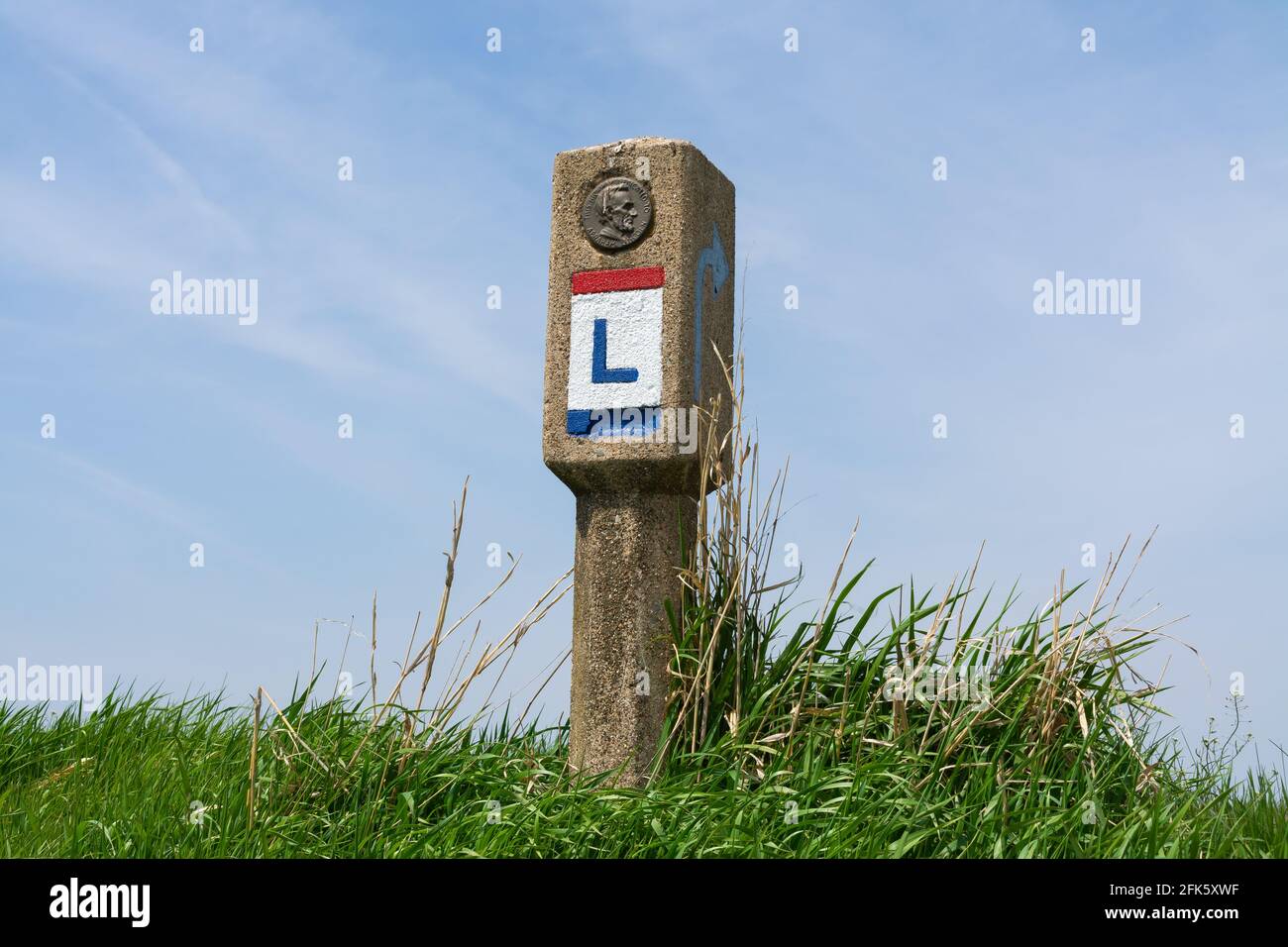 Original Lincoln Highway sign post in open field with blue skies and ...