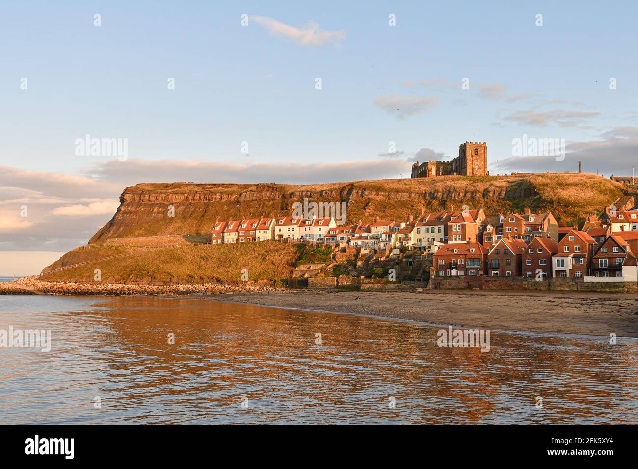 Whitby Harbour with the Church of St Mary on the headland at dusk ...