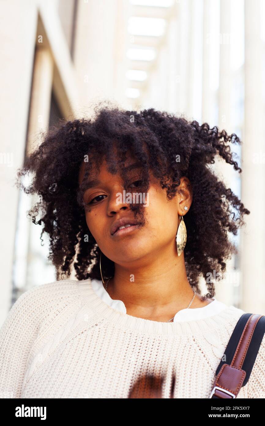 young pretty african girl posing cheerful on city background, lifestyle ...