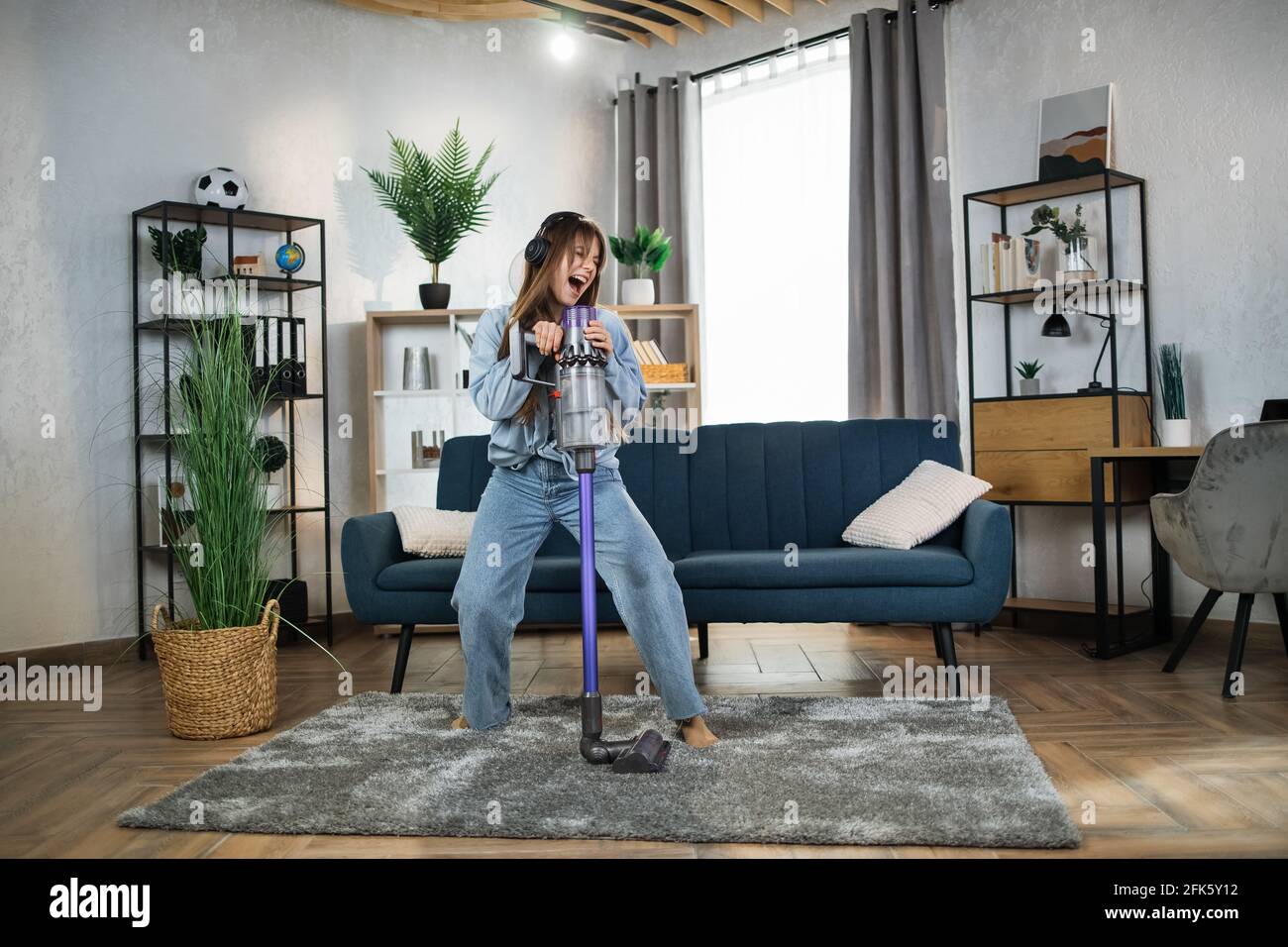 Woman cleaning home dancing vacuum hi-res stock photography and images ...