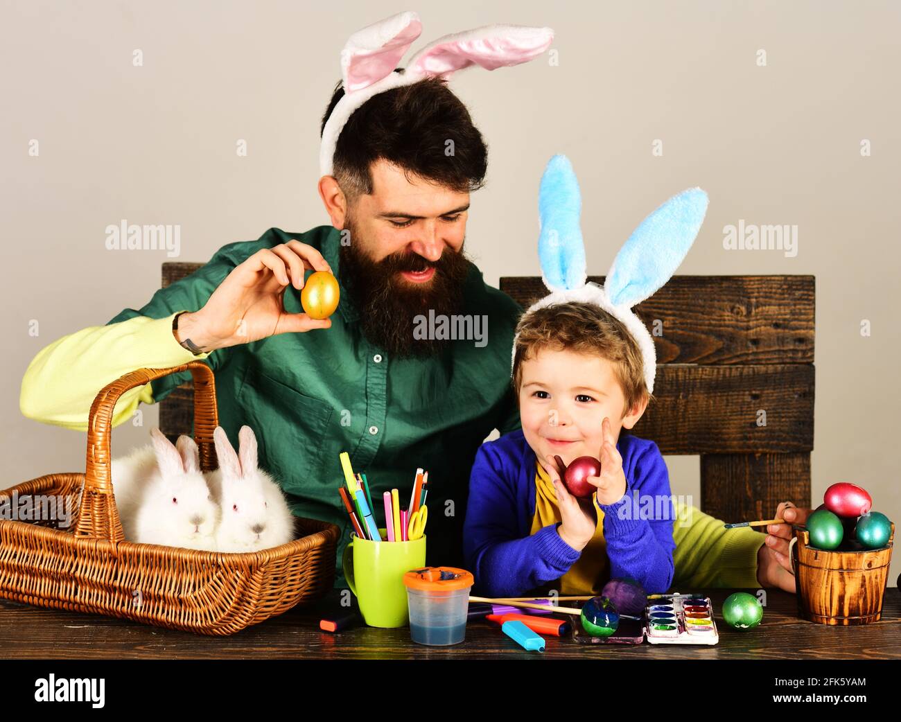 Happy father teaching son paint hi-res stock photography and images - Alamy