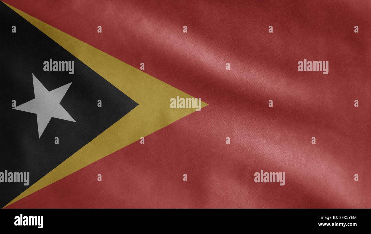 Timorese flag waving in the wind. Close up of East Timor banner blowing ...