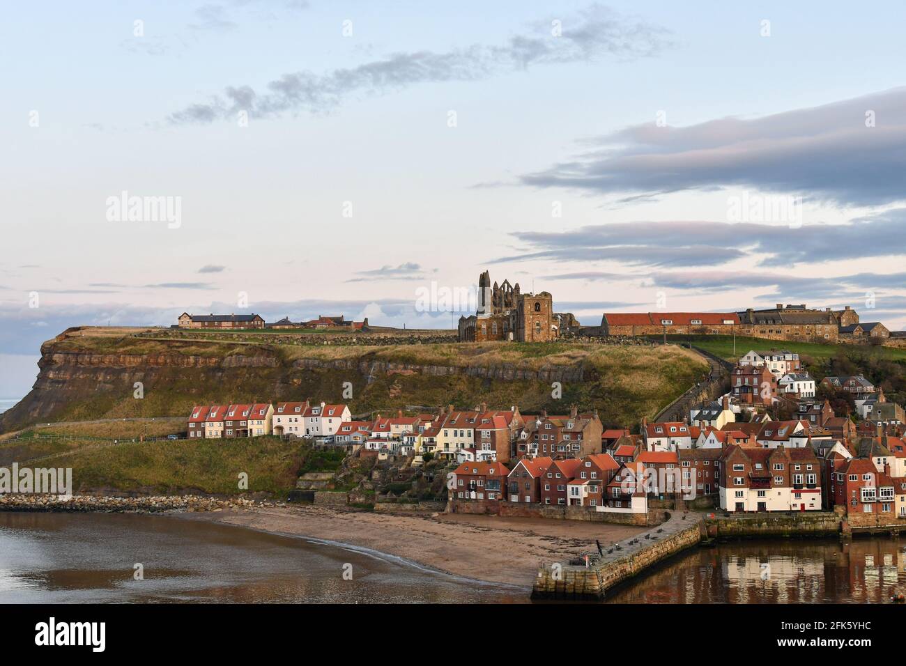Whitby Harbour with the Church of St Mary on the headland at dusk ...