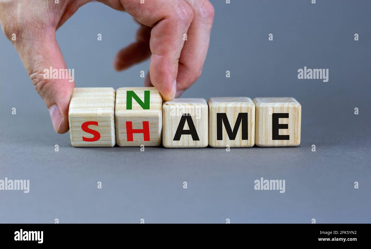 Name or shame symbol. Businessman turns wooden cubes and changes the ...
