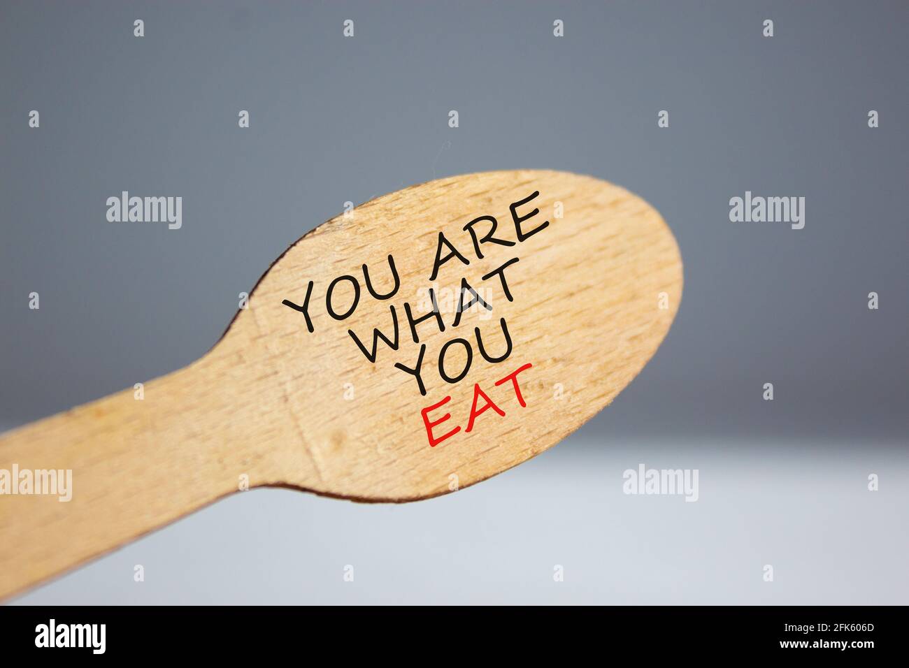 You are what you eat symbol. Wooden spoon on white background ...