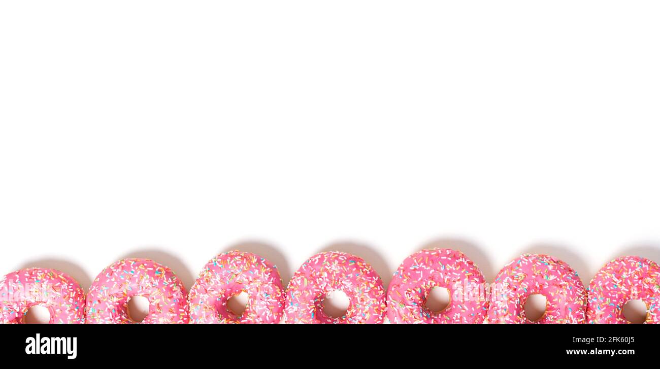 Bottom donuts border. Top view of yummy fresh homemade doughnuts. Light ...