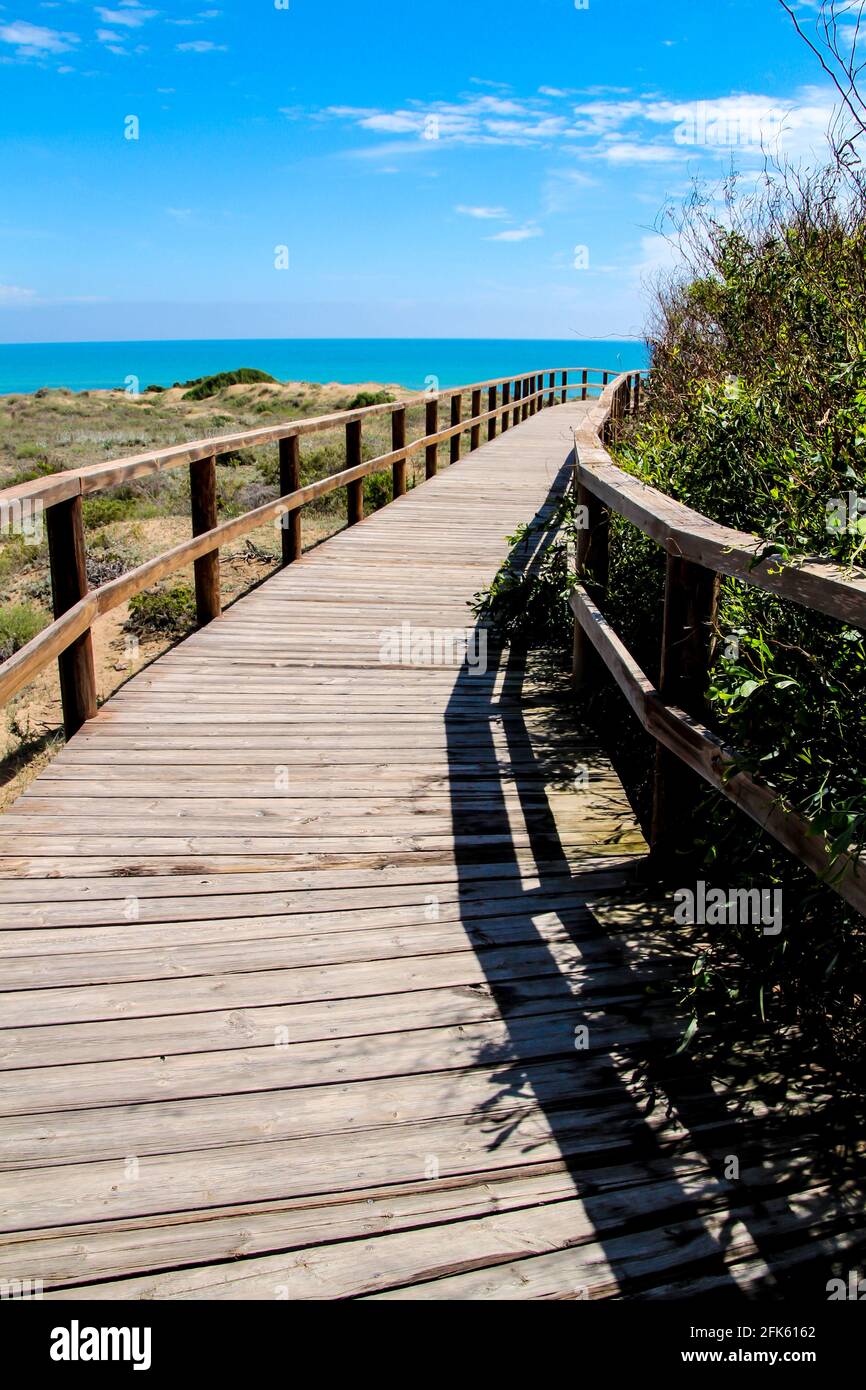 Wooden walkway to Arenales del Sol beach in a beautiful morning in ...