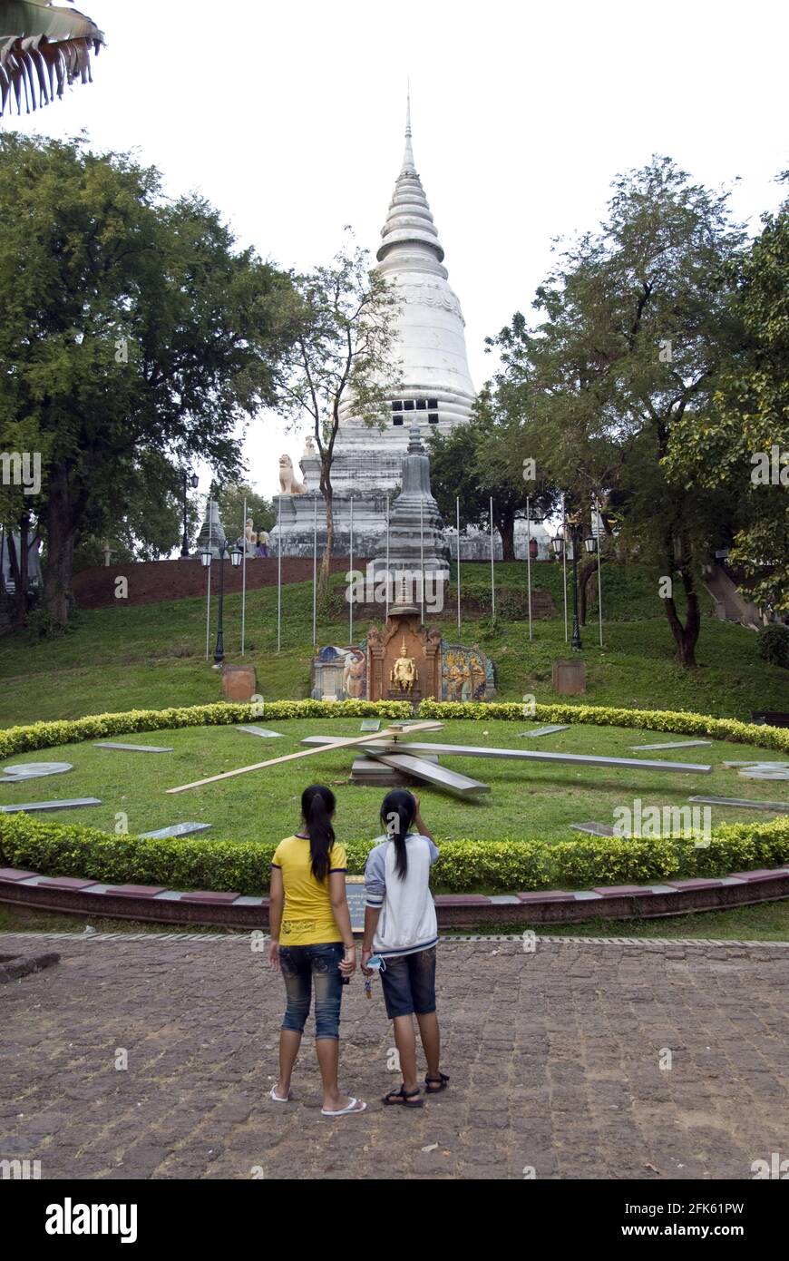A large clock is built into a garden at Wat Phnom (Mountain Pagoda), a ...