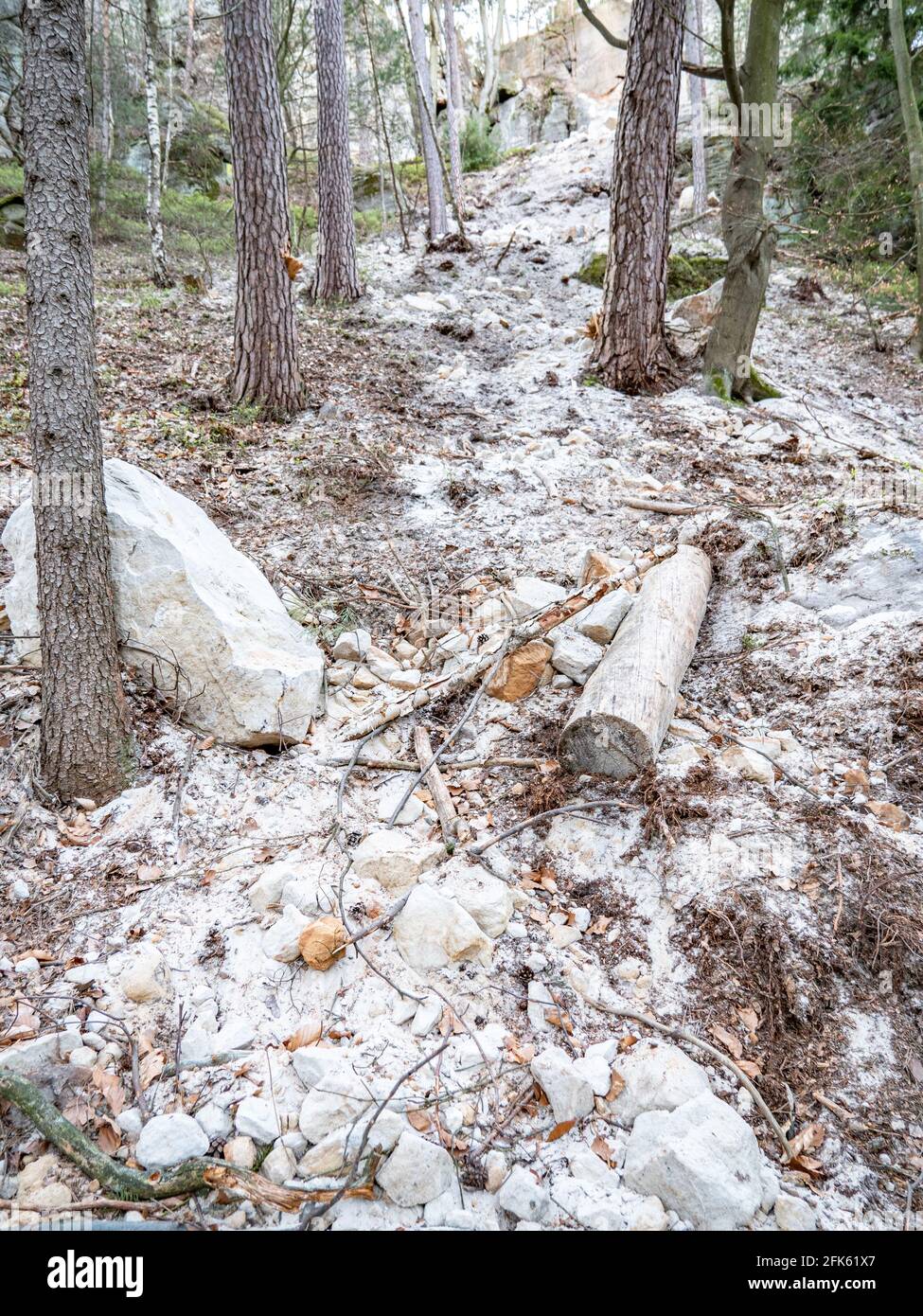 Collapsed rocky boulders fall down from sandstone rocks and landslide ...