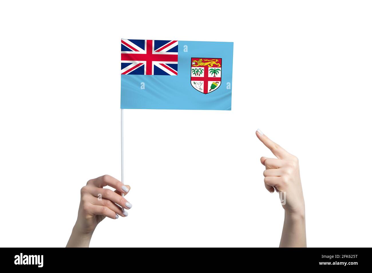 A beautiful female hand holds a Fiji flag to which she shows the finger ...