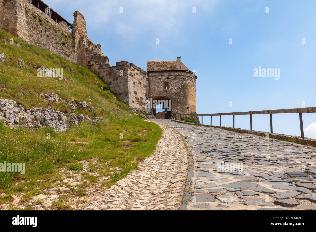A stone-paved road leads to the gates of an ancient knight's castle ...