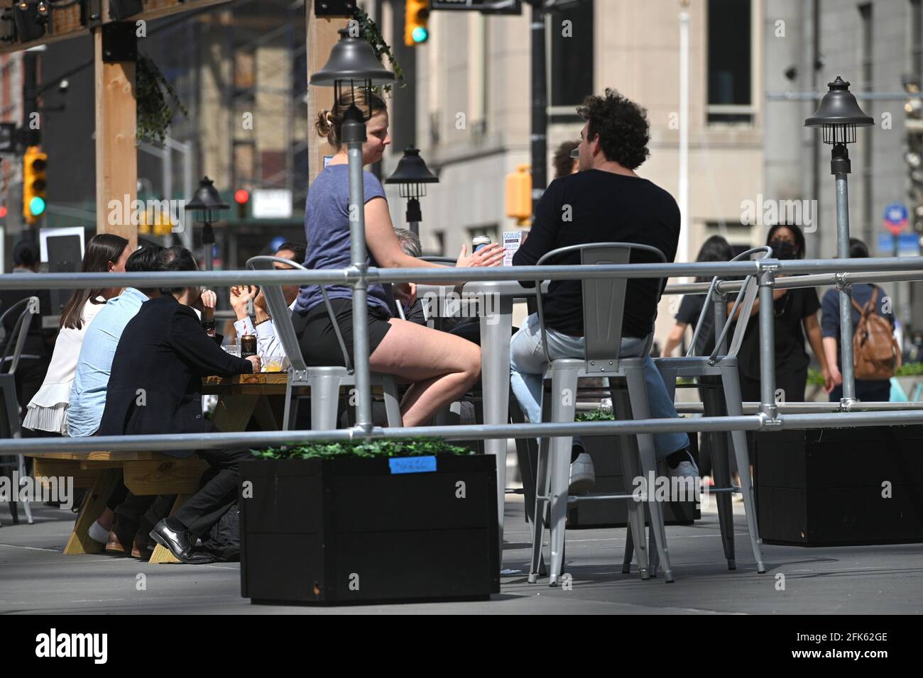 People sit outdoors at the Oculus Beer Garden, located at Two World ...