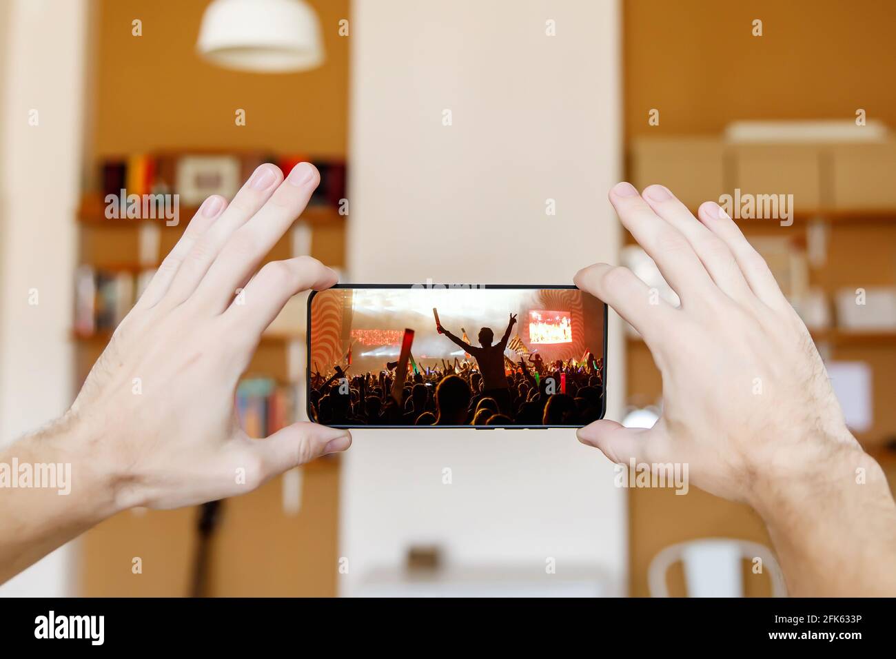 Concert festival show on the mobile phone screen at home Stock Photo ...