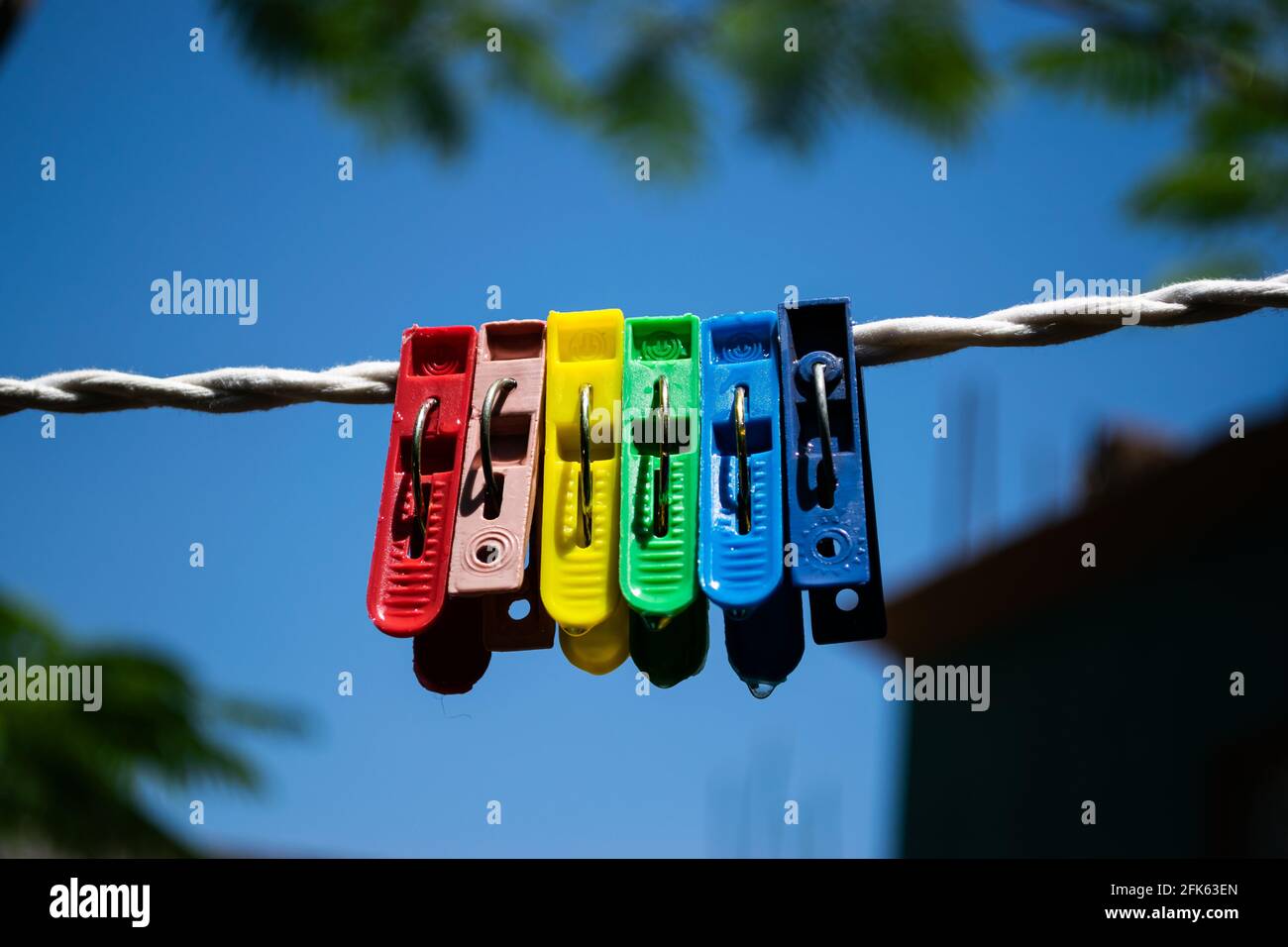 Closeup of colorful clothespin hanging on the string Stock Photo - Alamy