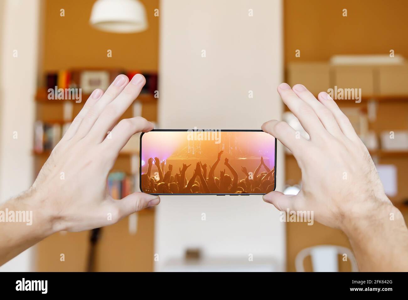 Concert festival show on the mobile phone screen at home Stock Photo ...