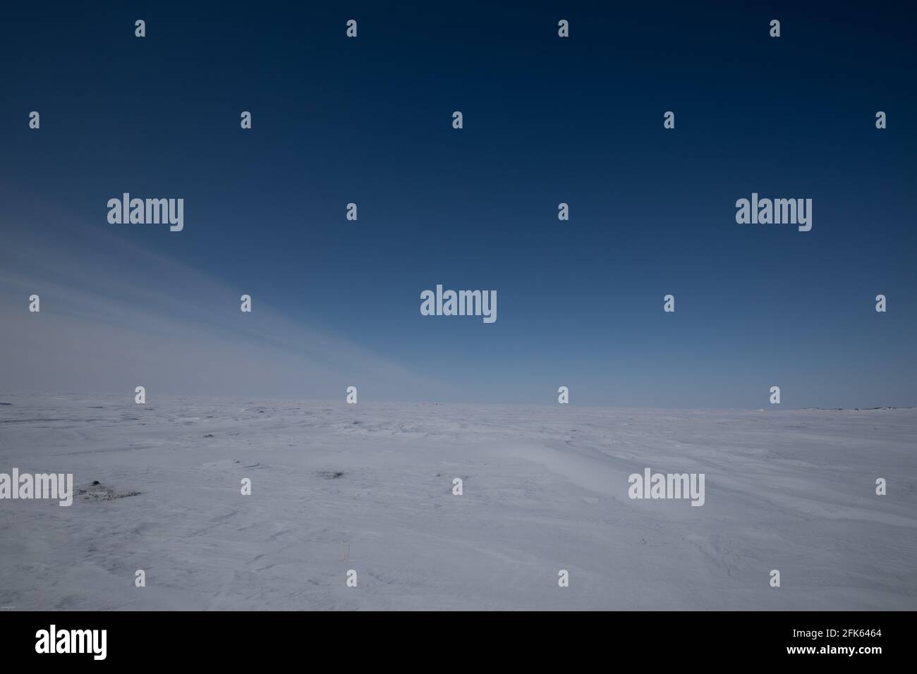 Frozen arctic landscape with snow on the ground near Arviat, Nunavut ...